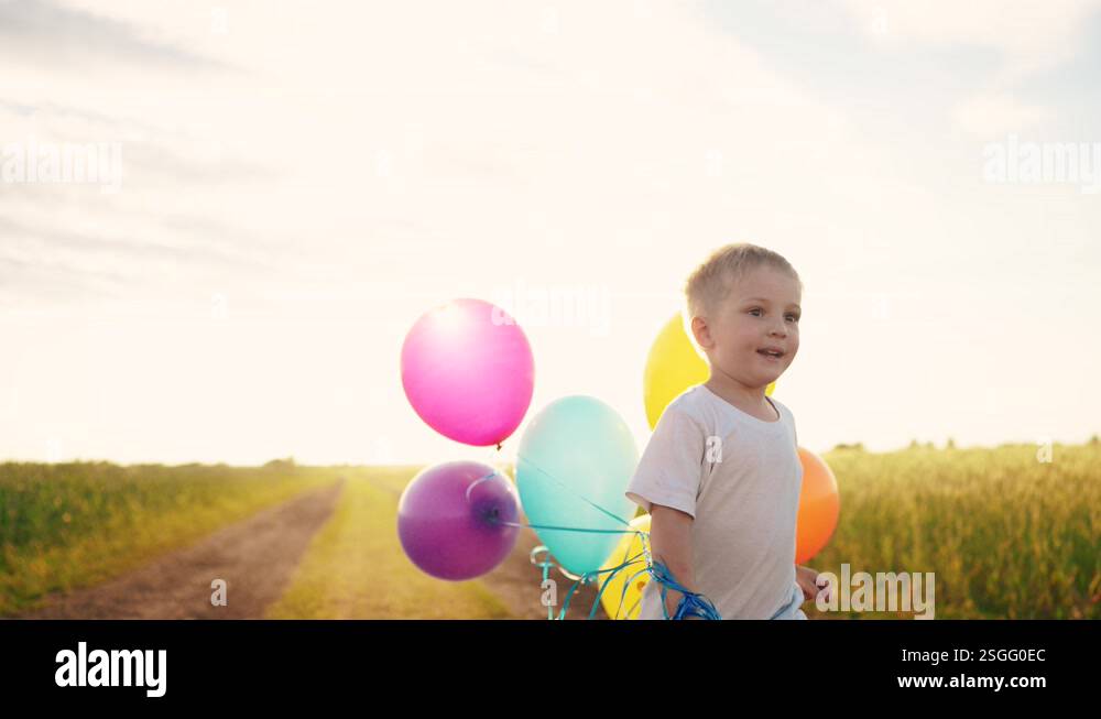 little baby boy run with balloons in lifestyle the park in nature ...