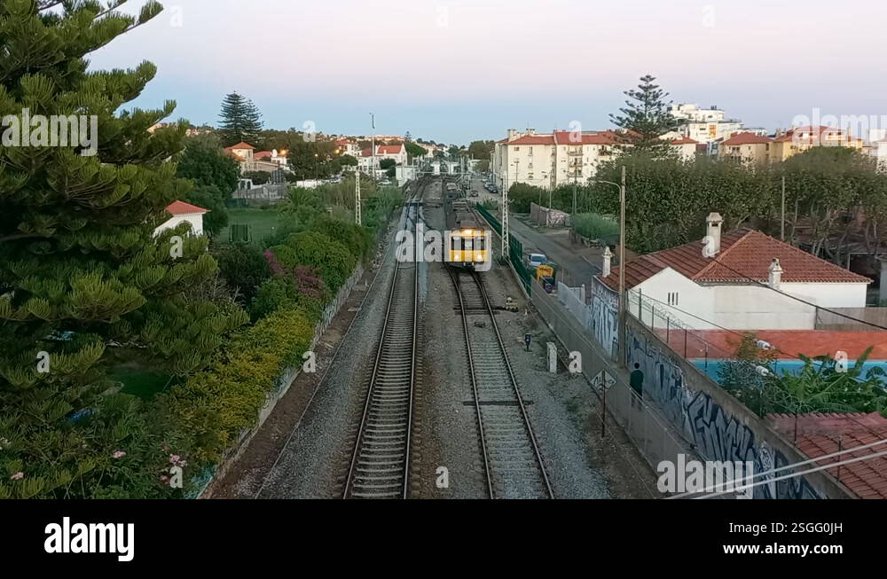Train that passes on the line through the village, with houses and ...