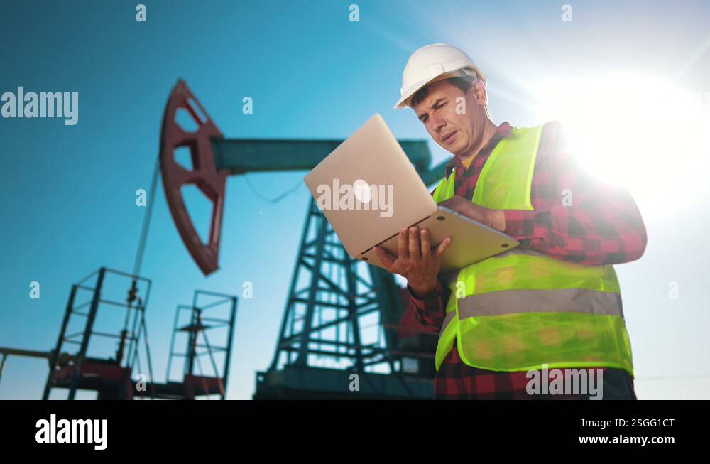 oil industry. engineer next to an oil rig. oil production business ...