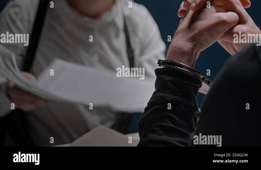 Female detective interrogates suspected criminal in handcuffs. Police ...