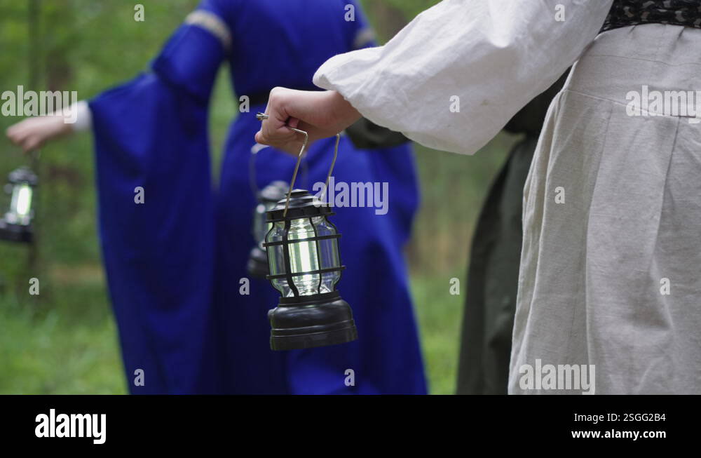Women in medieval dresses with lanterns walk through wood Stock Video ...