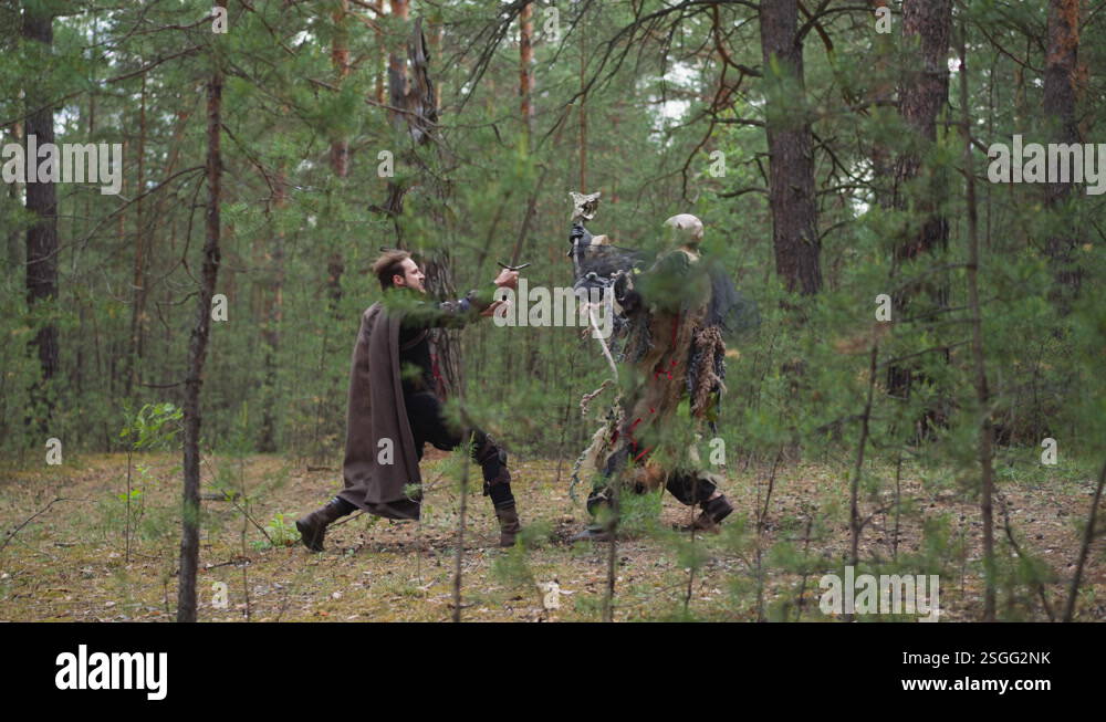 Armed man fights off scary beast attack in pine forest Stock Video ...