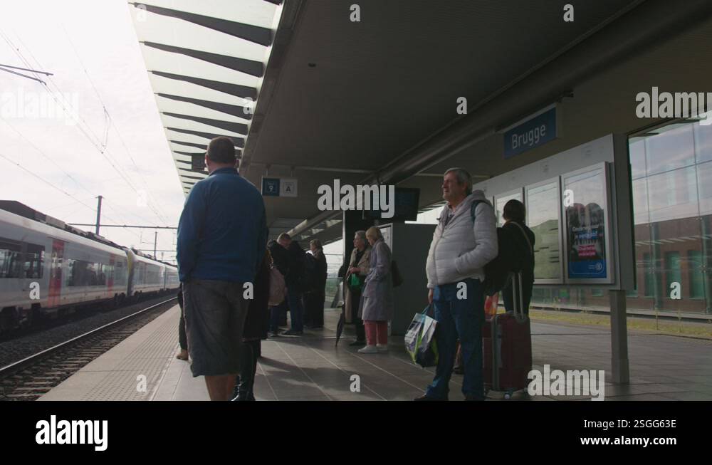 Commuters On The Platform Waiting For Train At The Brugge Railway ...