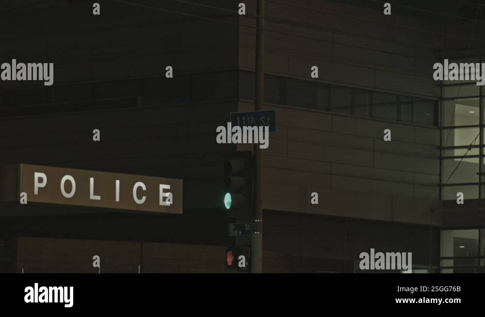 A side view of an old "Police Station" sign board is illuminating at ...