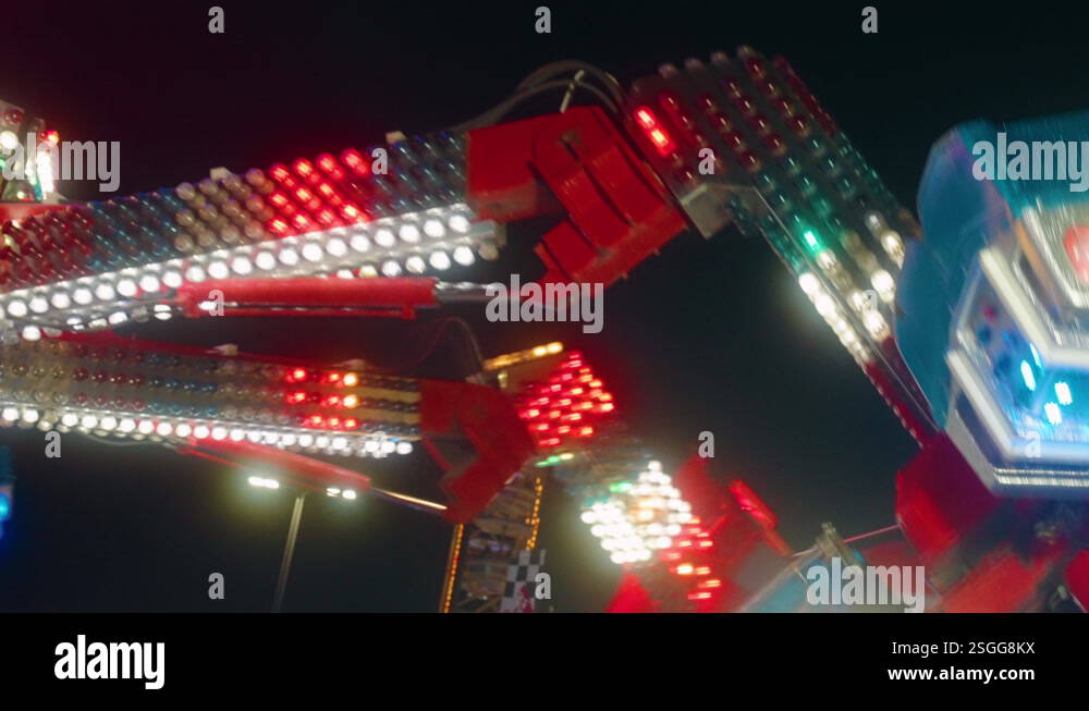 Neon lights flash on a warm night as people enjoy an evening of ...
