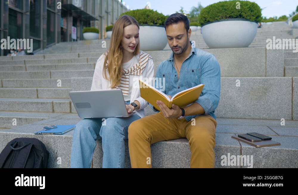 Two High School Students Study Together Sitting Outdoor at Stairs Using ...