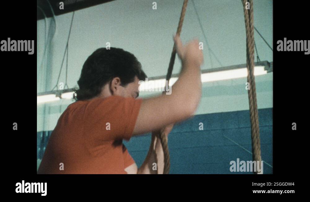 1990s: Boy pulling on rope through pulleys, lifting weights. Scientist ...