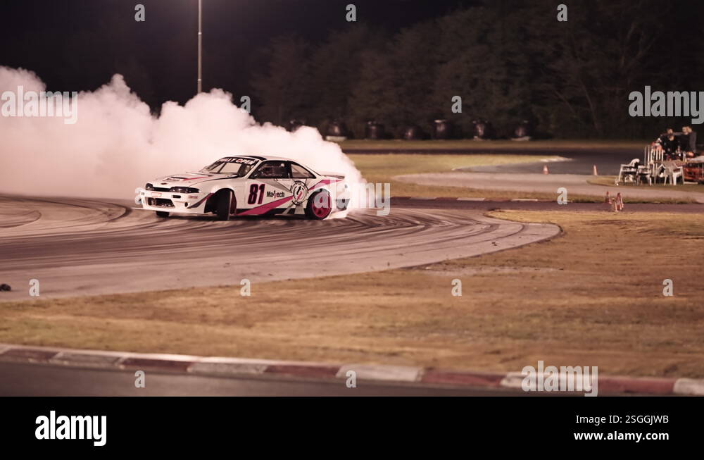 Car drifting long corner leaving huge smoke from tire burnout in slow ...