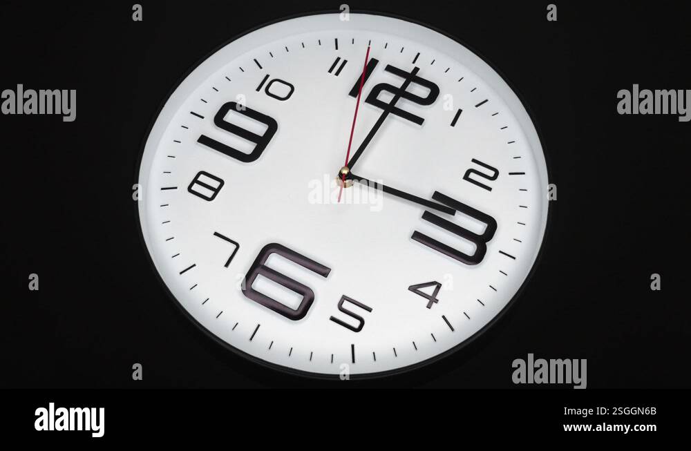 A White Wall Clock On Black Background With A Time Of 3.00 Am Or Pm. A ...