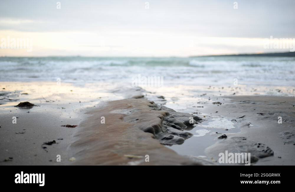 Smooth rock formations in the sand of an east coast beach in New ...