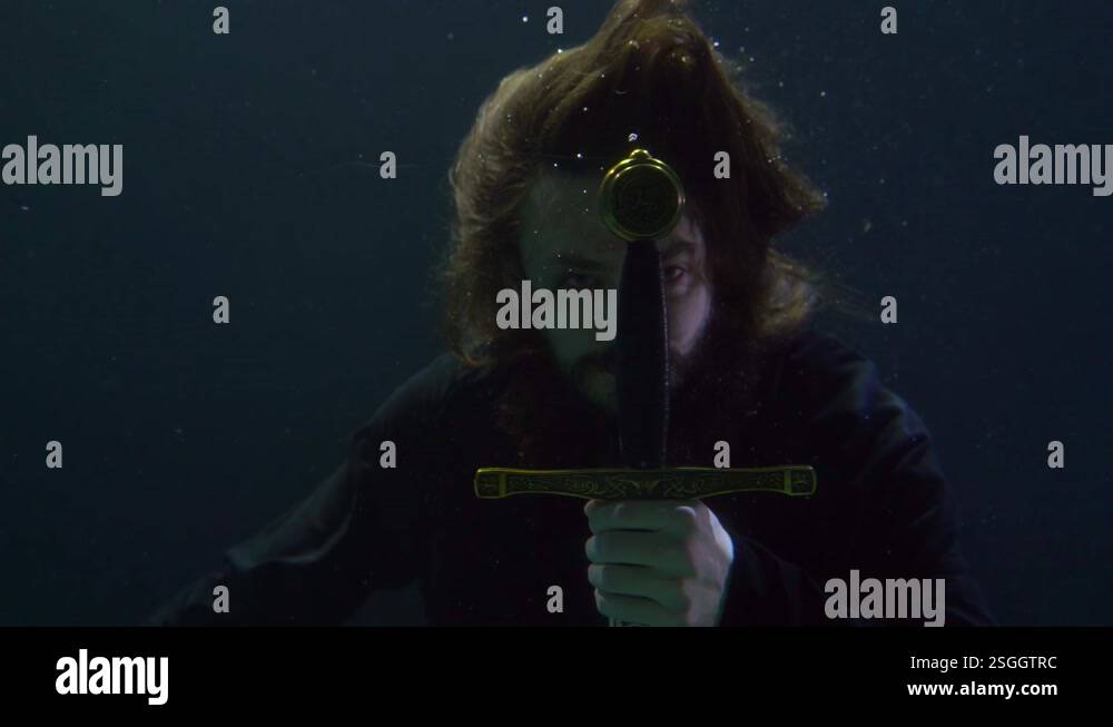 a medieval warrior with a sword under water waits for an attack on the ...