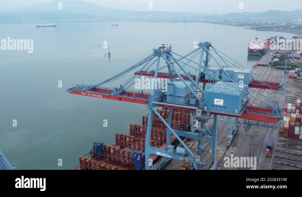 Loading cargo ship by cranes in Panjang International port Indonesia ...