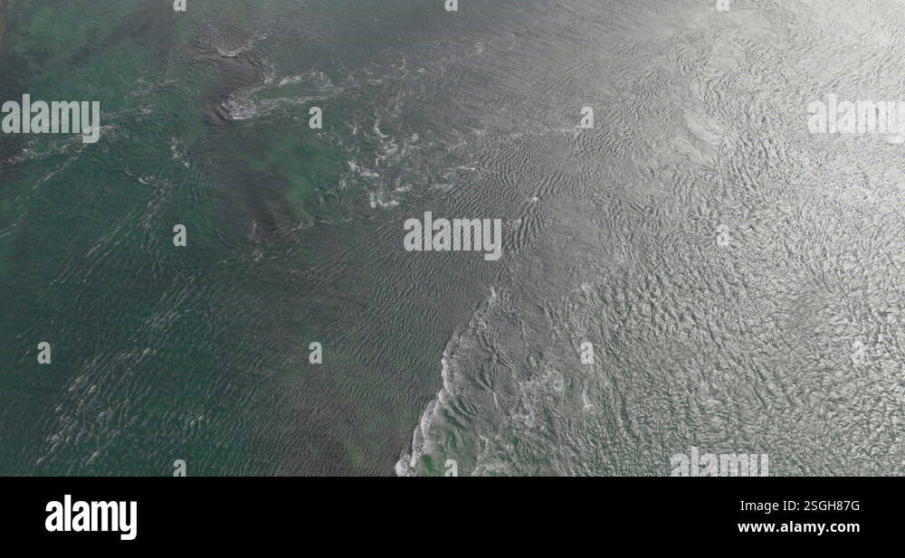 Zoom in of northern sea with a strong current. Aerial view. Slow motion ...