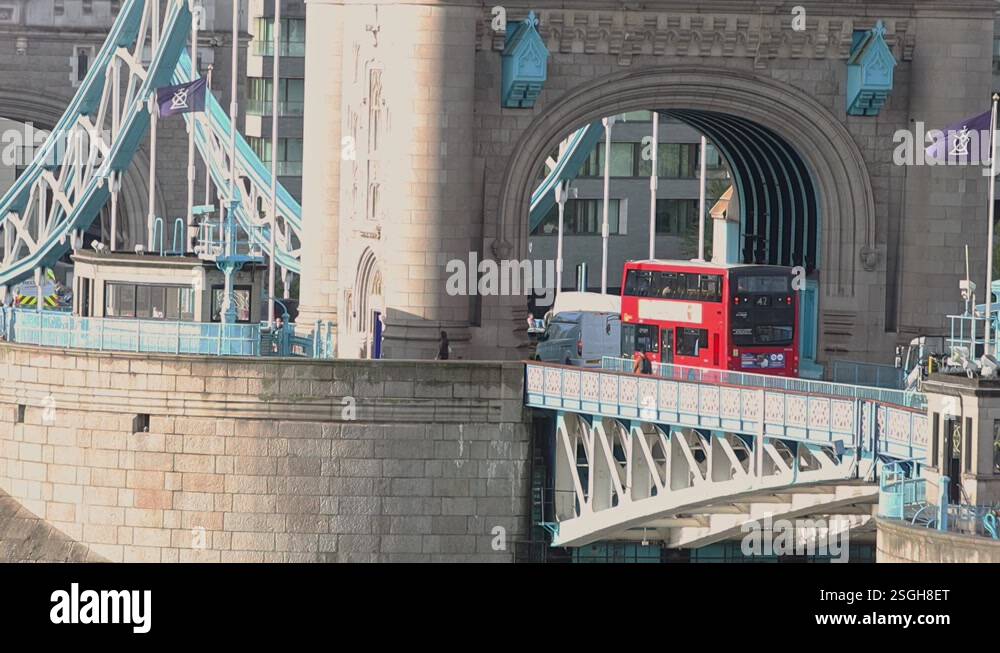 cars driving along tower bridge in London zoom out view of iconic ...