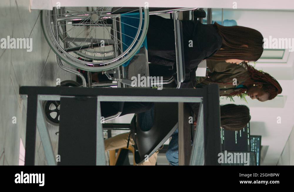 Vertical video: Programer with chronic disability typing source code on computer Stock Video ...