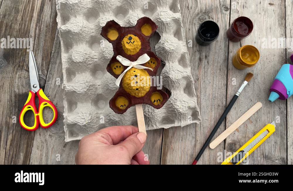A teddy bear on a stick made from an egg tray Stock Video Footage - Alamy
