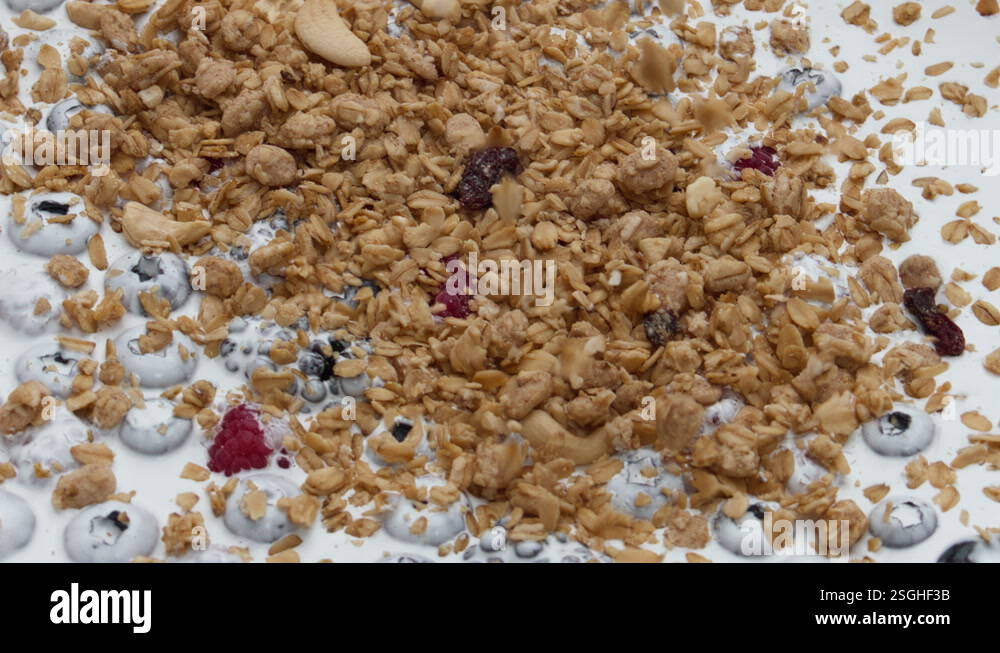 Healthy yogurt granola berries super slow motion close up. Dairy tasty ...