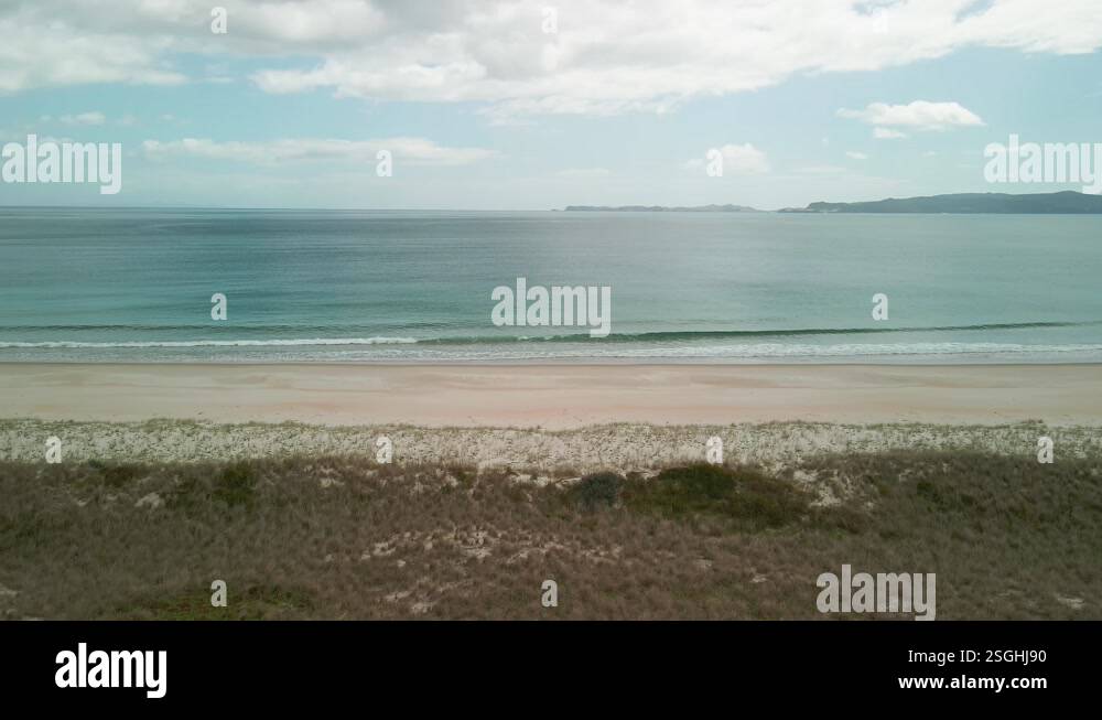 Flying over sand dunes into the ocean at low tide Stock Video Footage ...