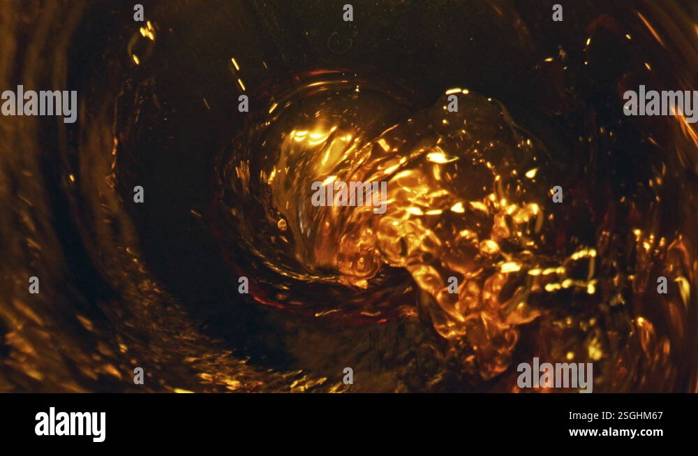 Alcohol liquid bubbling glass top view. Craft beer pouring from bottle ...