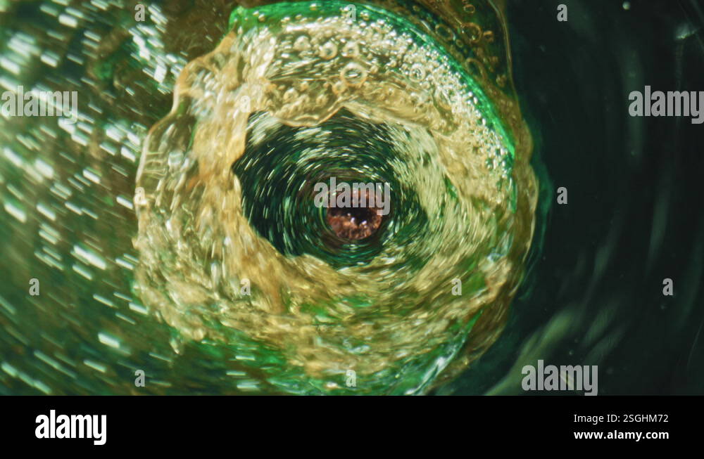 Splashing fizzy ale glass in super slow motion. Beverage jet spinning ...