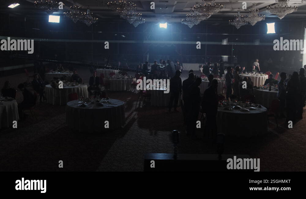 Actors and film crew prepare for shooting in restaurant hall Stock ...