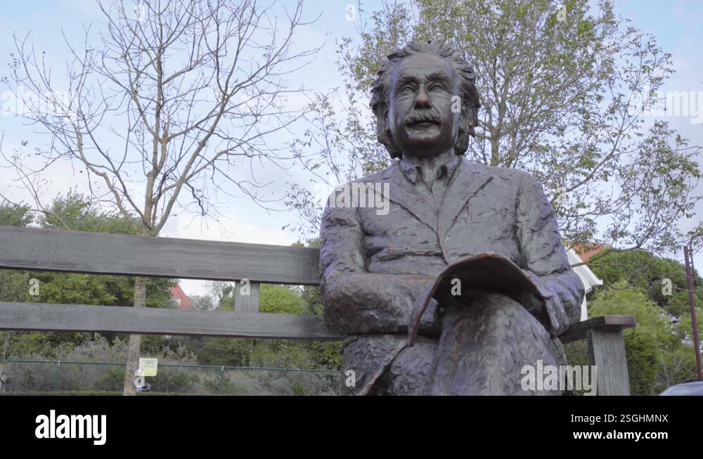Bronze statue of famous scientist Albert Einstein sitting on a bench in ...
