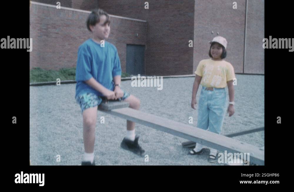 1990s: Girl gets on the see-saw. Boy on see-saw, girl jumps on behind ...