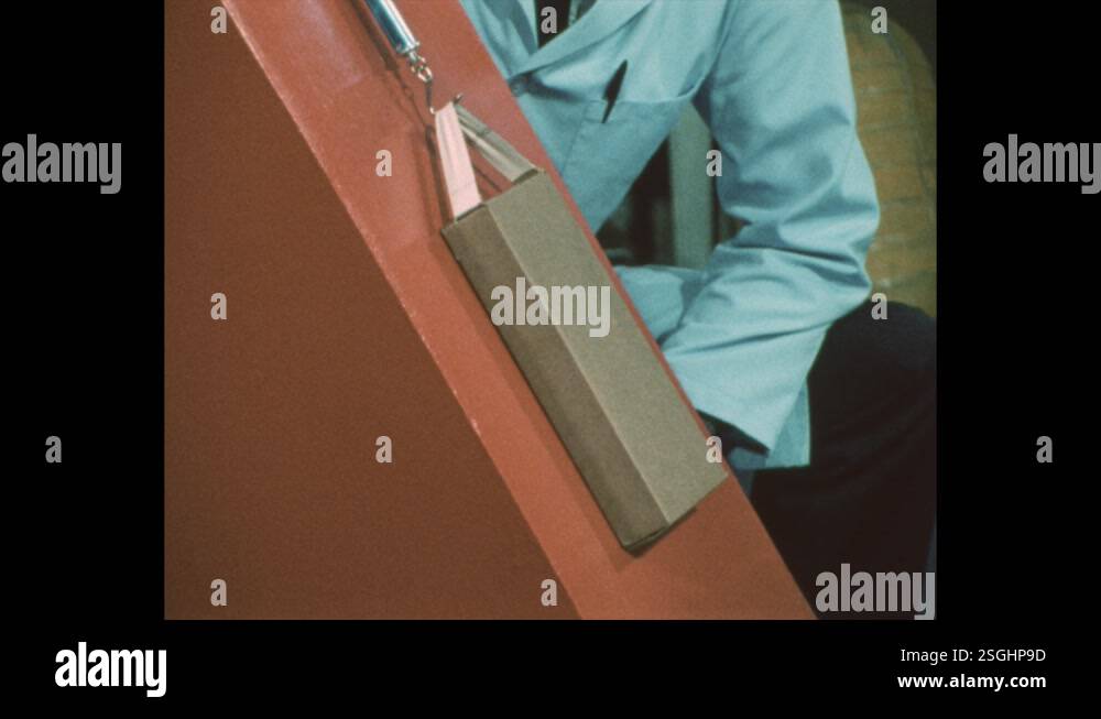 1990s: Scientist kneeling beside ramp with scale and weight. Animated ...