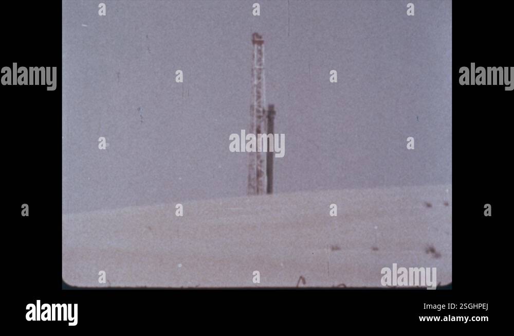 1980s: Tilt up sand dunes, zoom in on oil rig. Map of Middle East ...