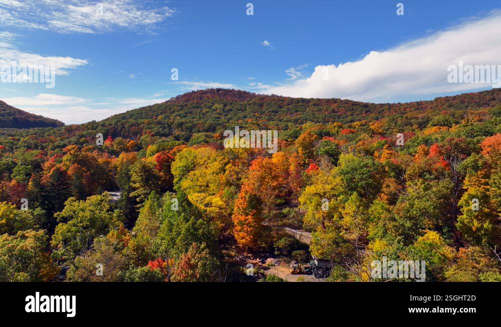 An aerial view high over colorful trees during the fall foliage in ...