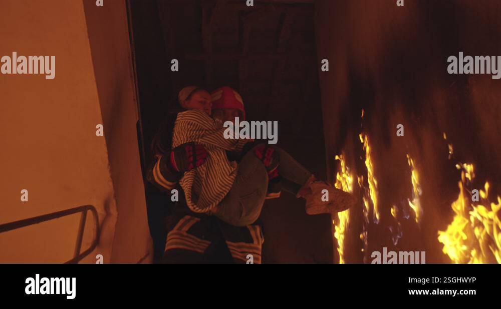 Brave Fireman Descends Stairs of a Burning Building and Holds Saved ...