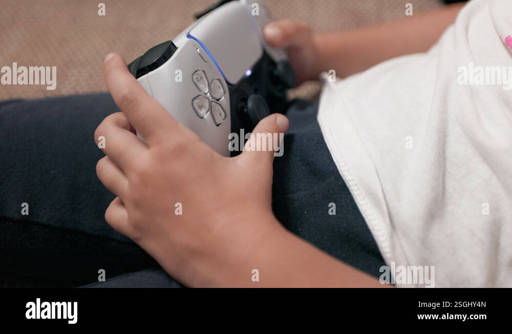 Close view: Little boy or girl is playing a game on a modern video ...