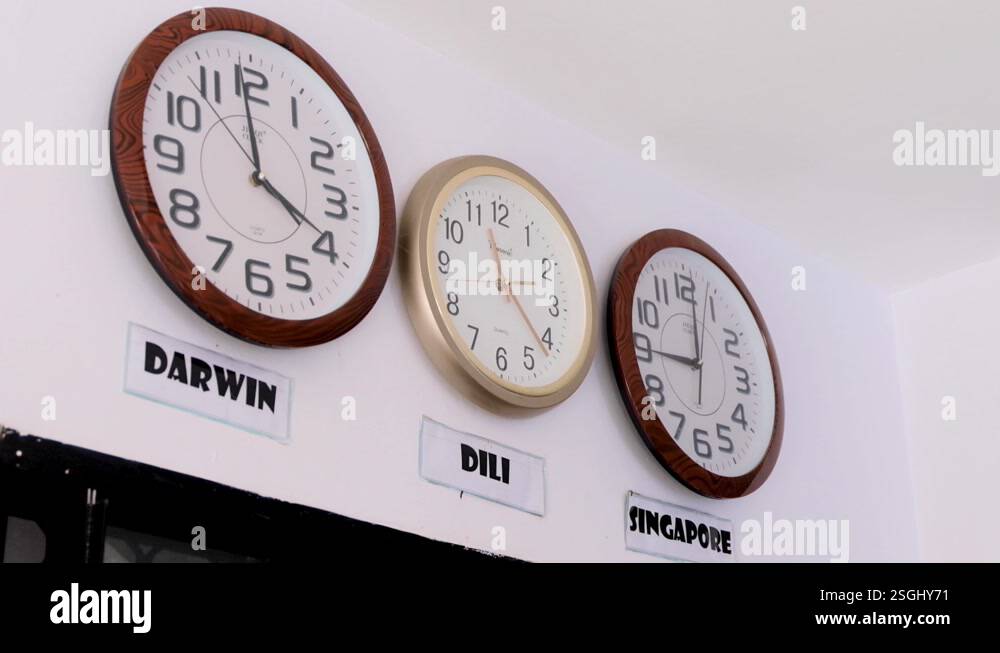 World clocks on wall with time zones from Dili Timor Leste, Darwin ...