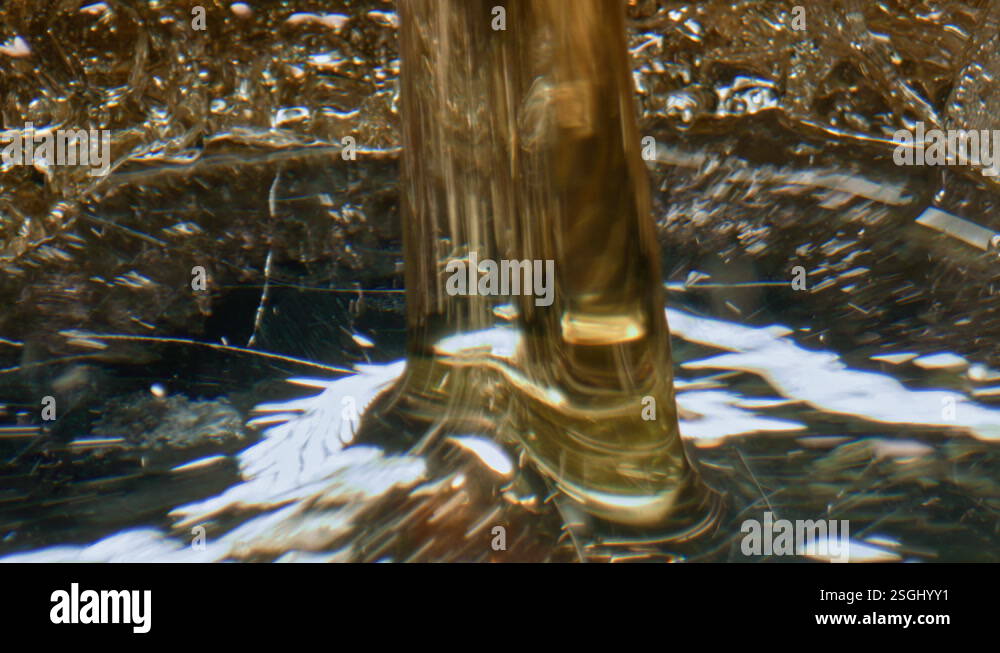 Wheat ipa filling glass closeup. Fresh alcoholic hoppy swash liquid in ...