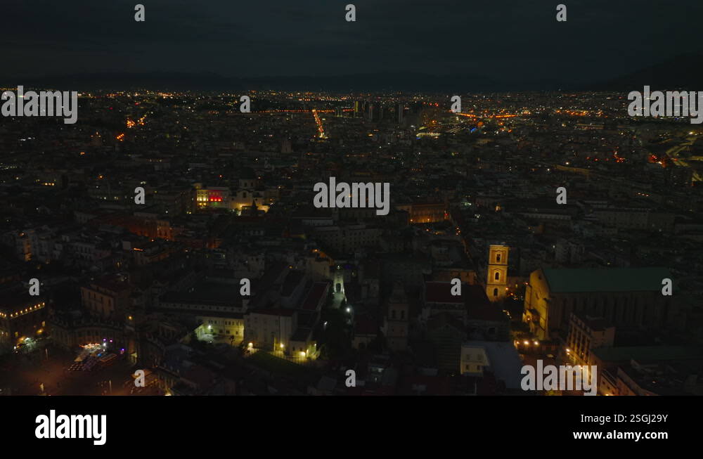 Side fly above night city. Buildings, streets and historic landmarks in ...