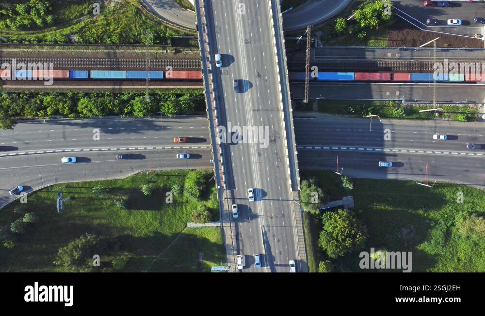 4k Top view of cars drive on intersecting roads and railroad in city ...