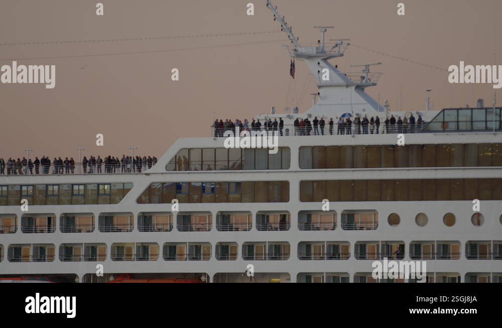Passengers Standing Along Top Deck Of Cruise Ship During Golden Hour ...