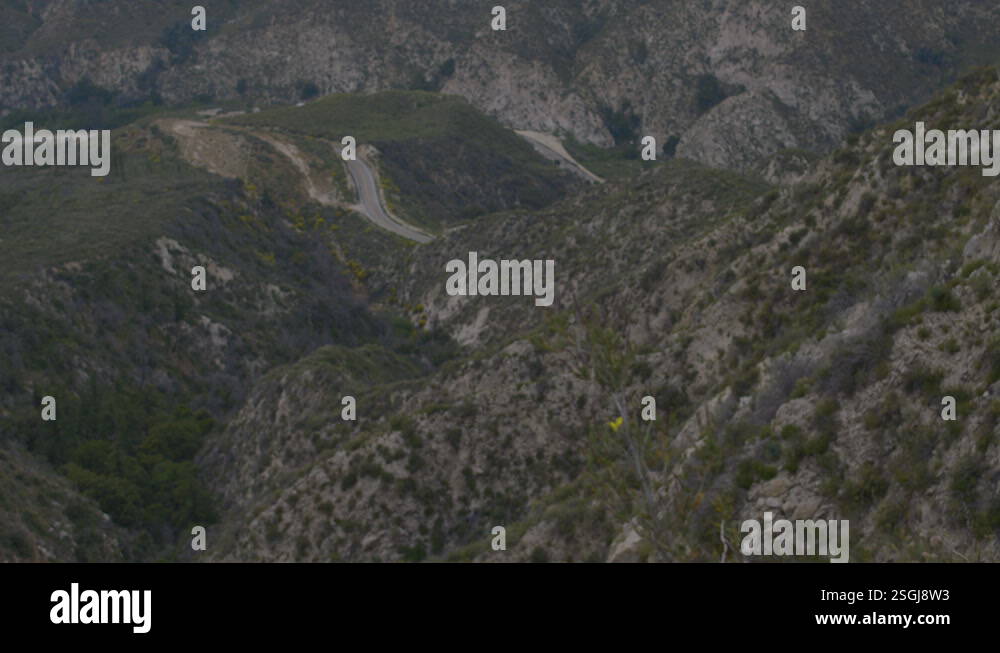 Ascending shot of rocky San Gabriel mountain range with sparse ...