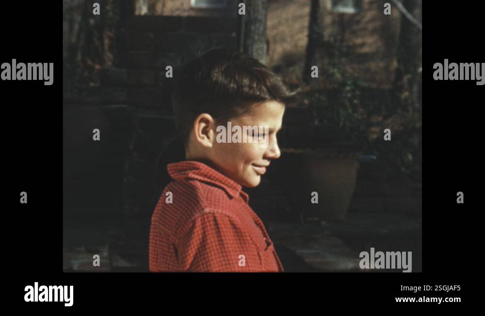 1950s: back of boy. Boy turns around. Boy looks over shoulder. Boy ...
