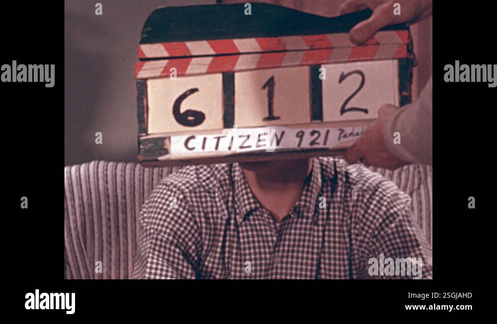 1950s: Citizen 921 clapper board in front of young actor’s face. Actor ...