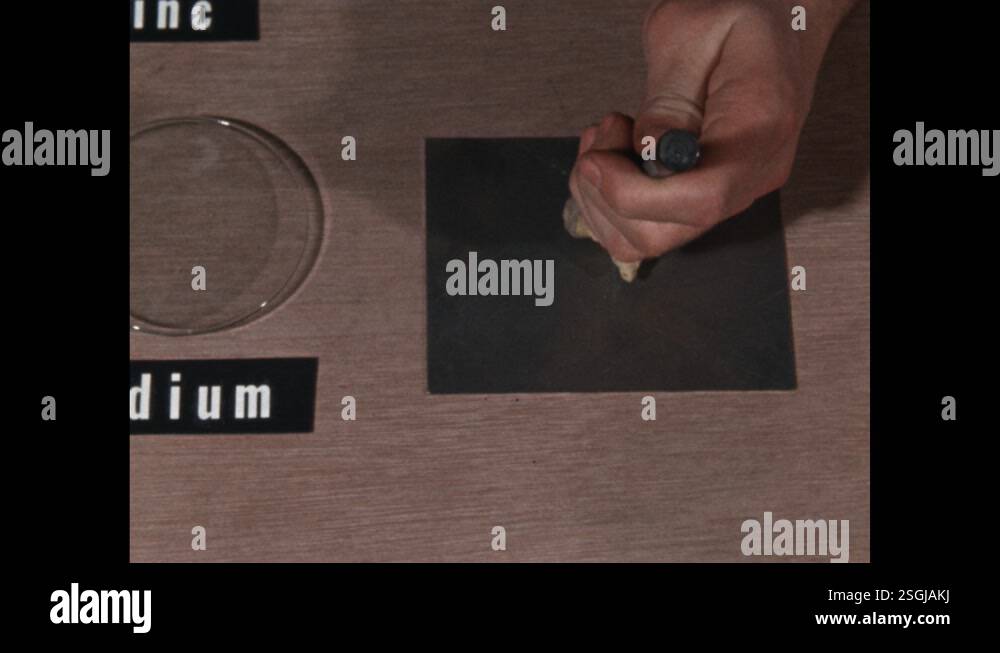 1960s: Hand moves radium to piece of paper, hits it with hammer and ...