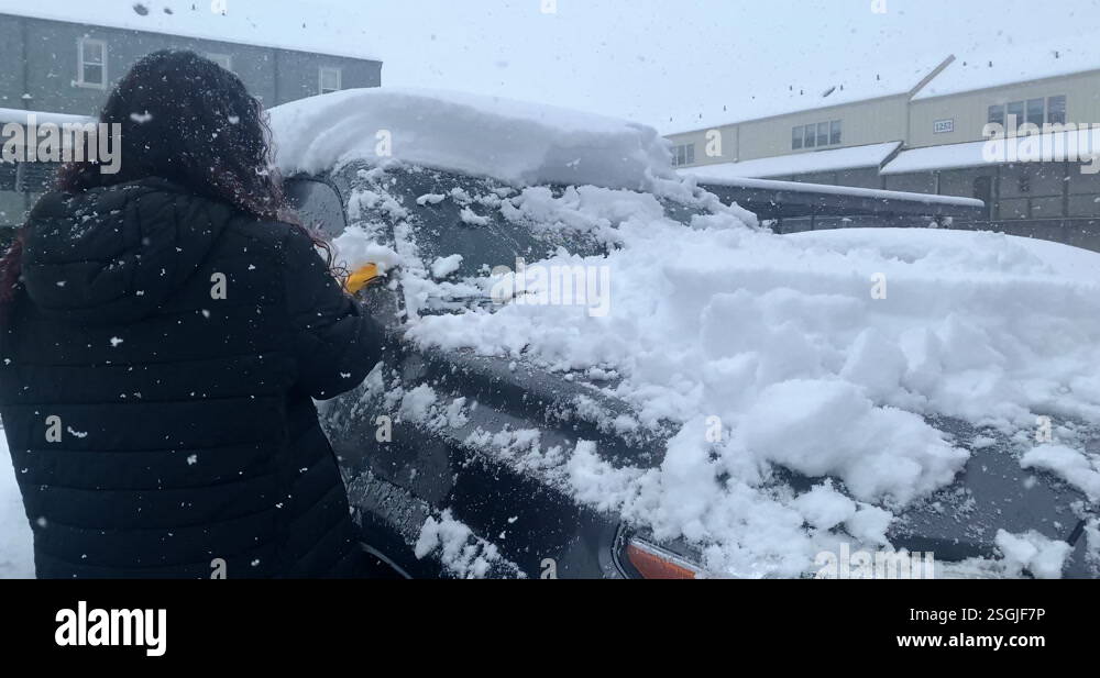 Woman Clearing off Snow From Truck During a Stormy Day in Montana, 4K ...