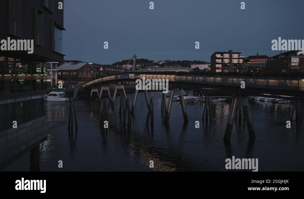 A static shot of flower bridge on the river Nidelva and shopping area ...