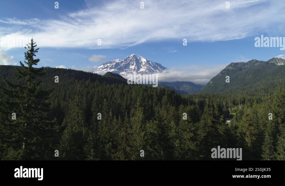 Aerial pushing in to clear view of Mount Rainier volcano in Washington ...