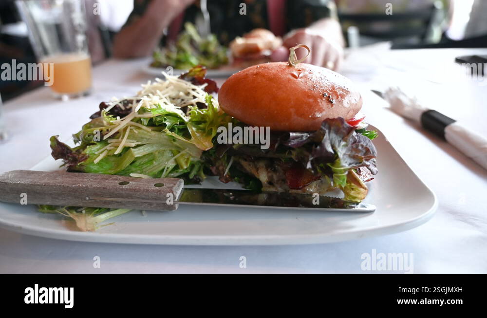 Restaurant style burger sandwich and side salad Stock Video Footage - Alamy