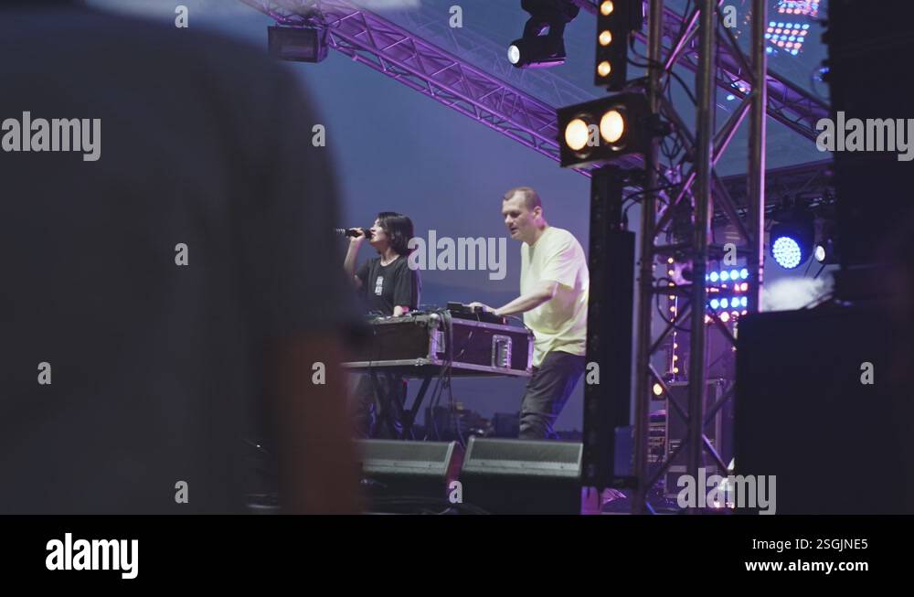 Popular singer with DJ performs music show in night city Stock Video ...