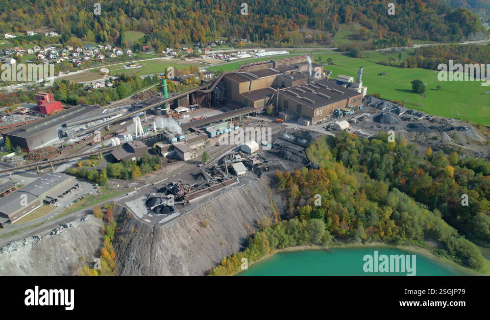 AERIAL: SIJ Acroni steel factory in embrace of alpine landscape in fall ...
