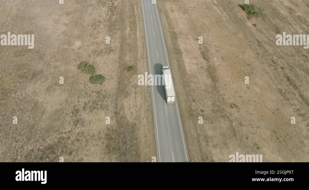 One Semi Truck with white trailer and cab driving, traveling alone on ...