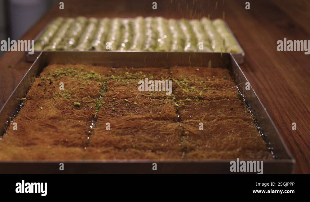 Kadaifi dessert in the pastry case is sprinkled with pistachios on top ...