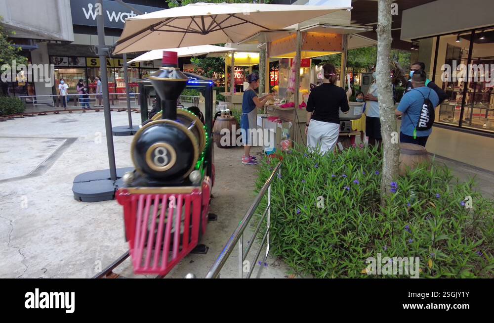 Malays family enjoy the ride of Choo Choo Train. People buy pop corn ...